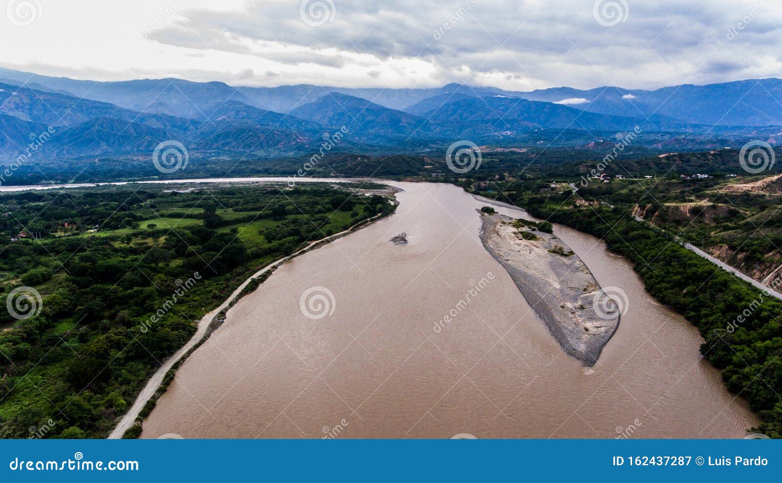 Wide Brown River with Chain of Mountains Stock Image - Image of ...