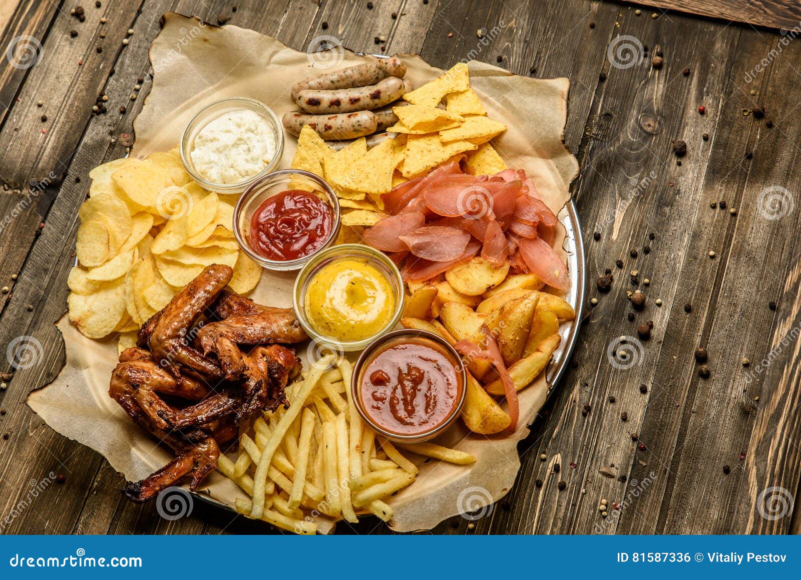 Wide Selection of Snacks for Beer with Different Sauces on Parchment ...