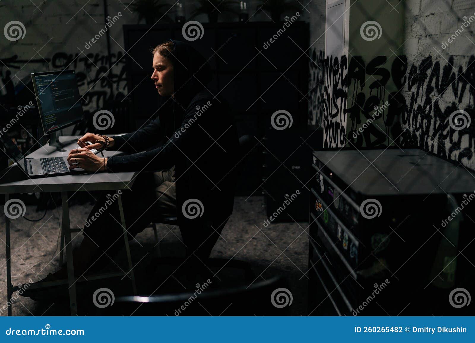 Wide Shot of Confident Hacker Man in Black Sweatshirt Using Laptop and ...