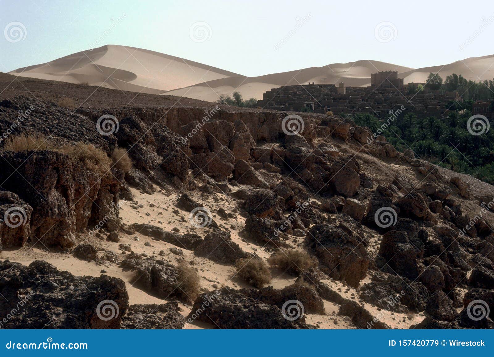 Wide Shot of a Rocky Hill Surrounded by Sandy Mountains and Trees Stock ...