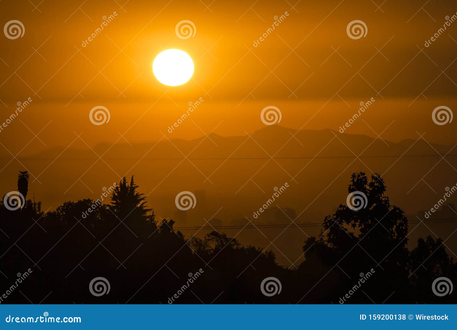 Wide Shot of the Sky during Sunset with the Bright Sun and the City ...
