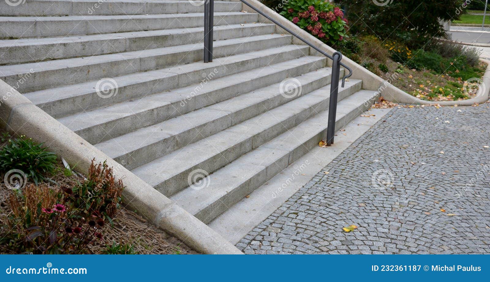 Wide Stone Staircase with Railings in the Middle of the Ramp. Forged ...