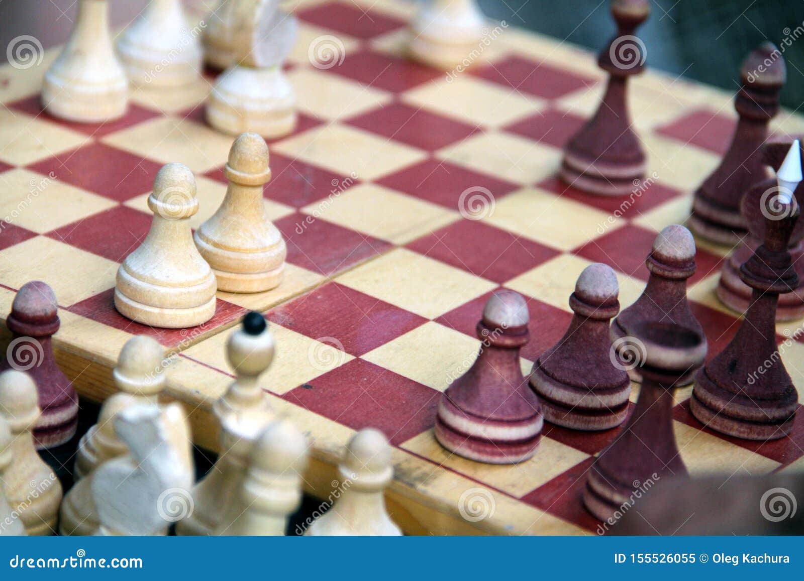 Widely Cropped Image of a Human Hand Moving a Dark Chess Piece at the ...