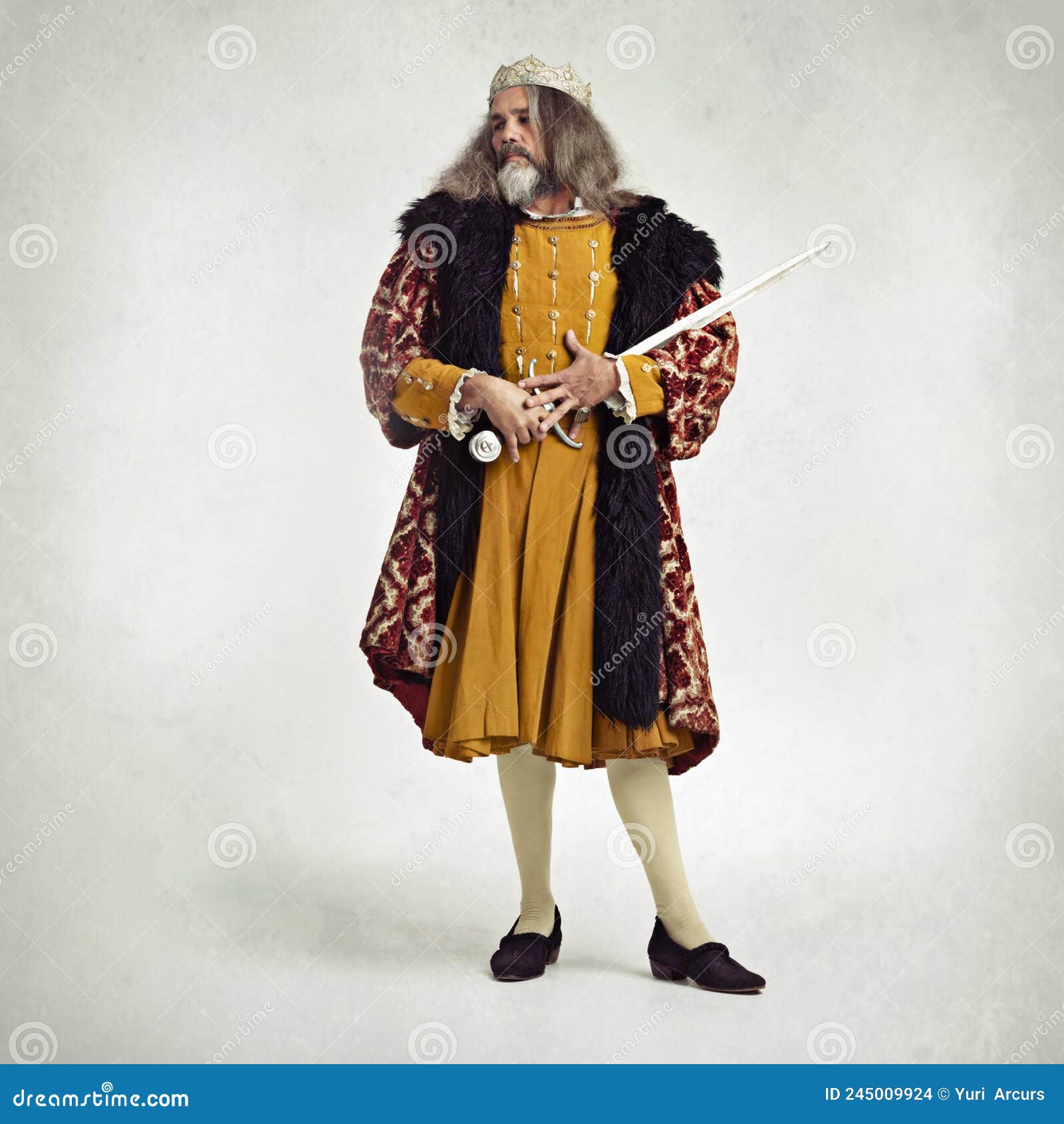 Wielding the Sword of Kings. Studio Shot of a Richly Garbed King ...
