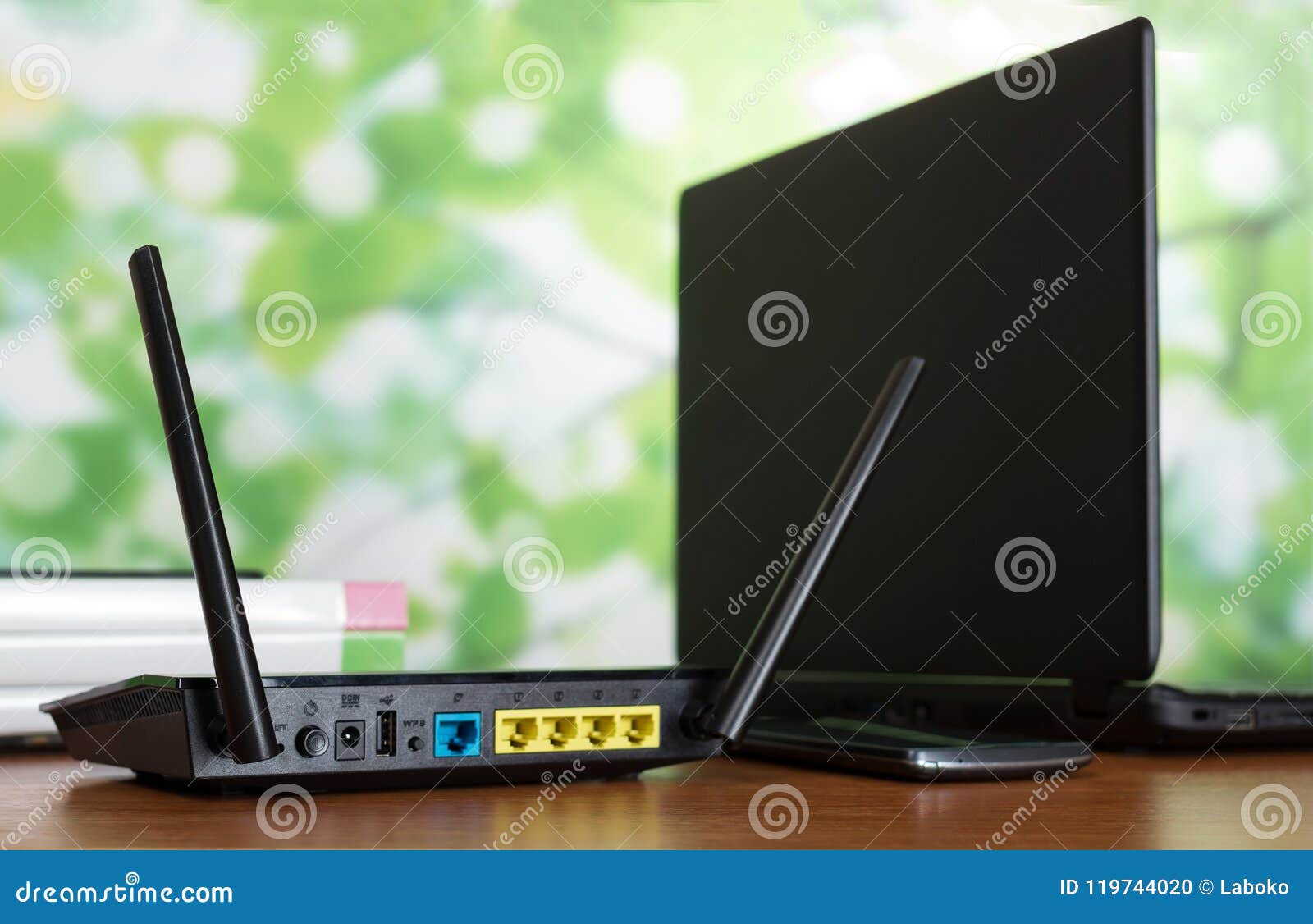 WiFi Router, Cable Connection Socket And Laptop On Table Stock Photo ...