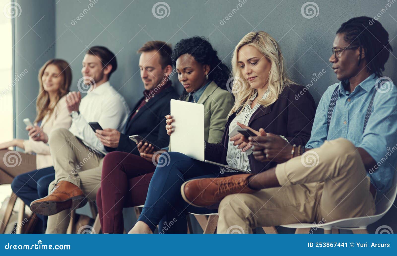 On the Wifi while Waiting. a Group of Businesspeople Using Different ...