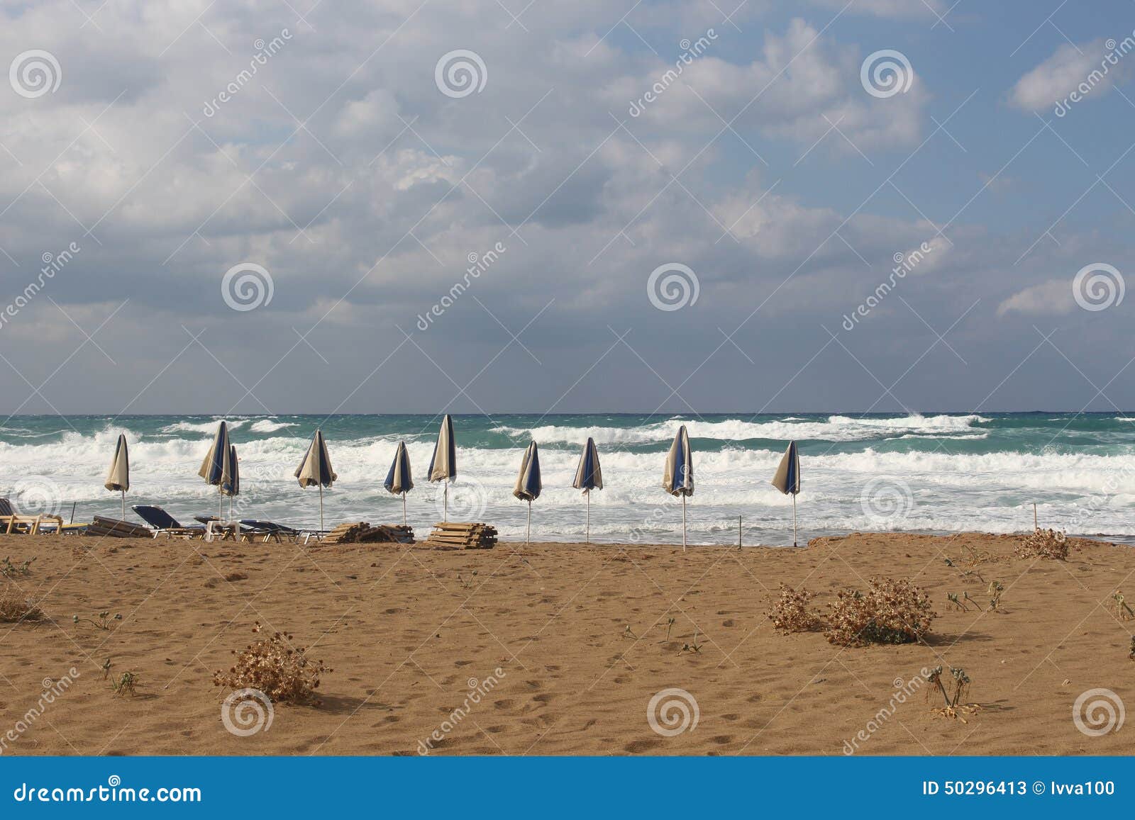 Wild beach scene in Crete. stock image. Image of umbrellas - 50296413