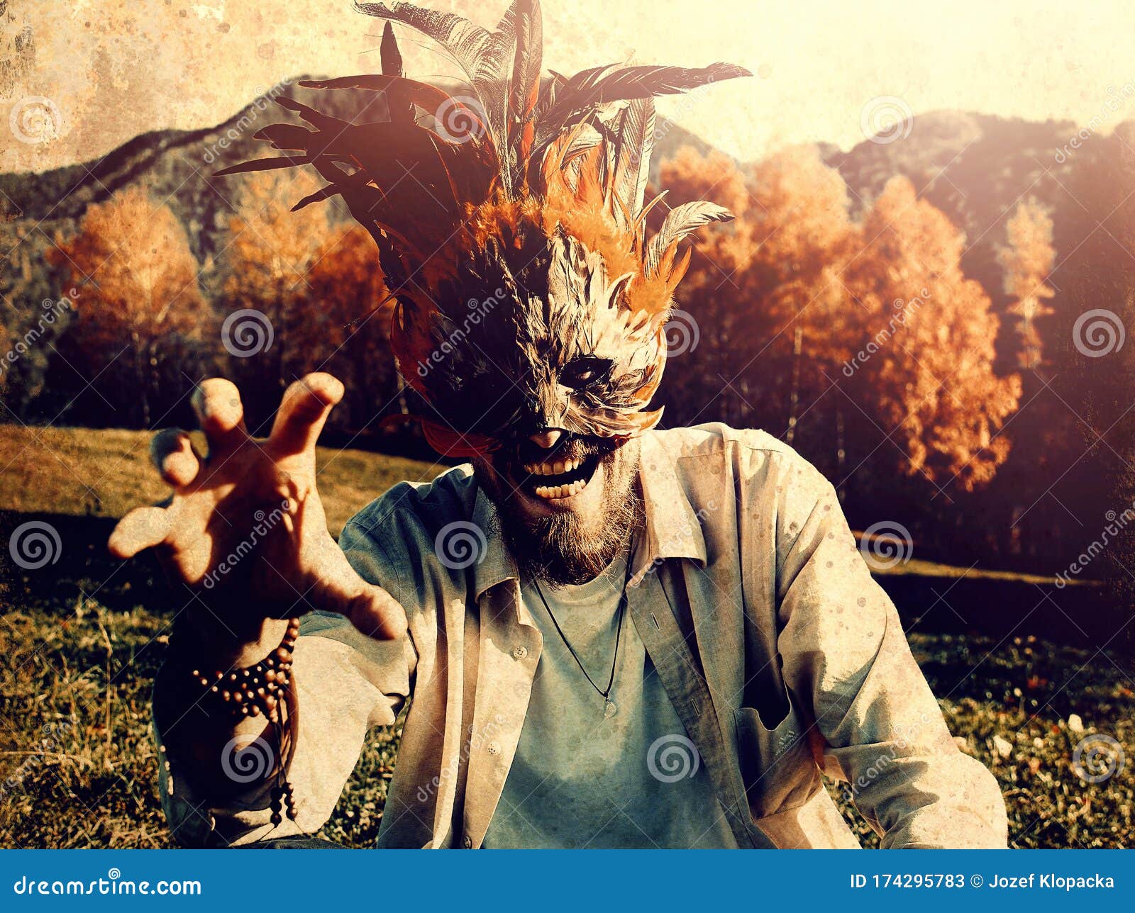 Wild Man with a Colorful Feather Face Mask. Stock Image - Image of ...