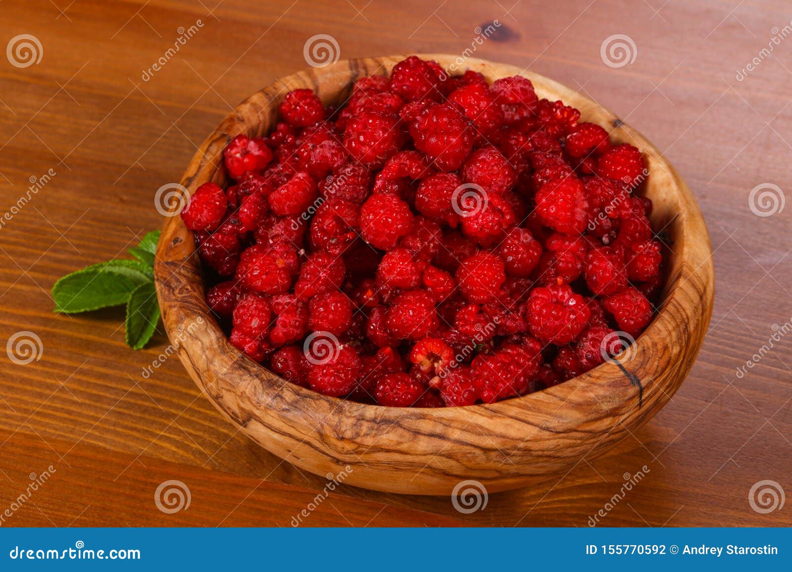 Wild raspberry in the bowl stock photo. Image of wooden - 155770592