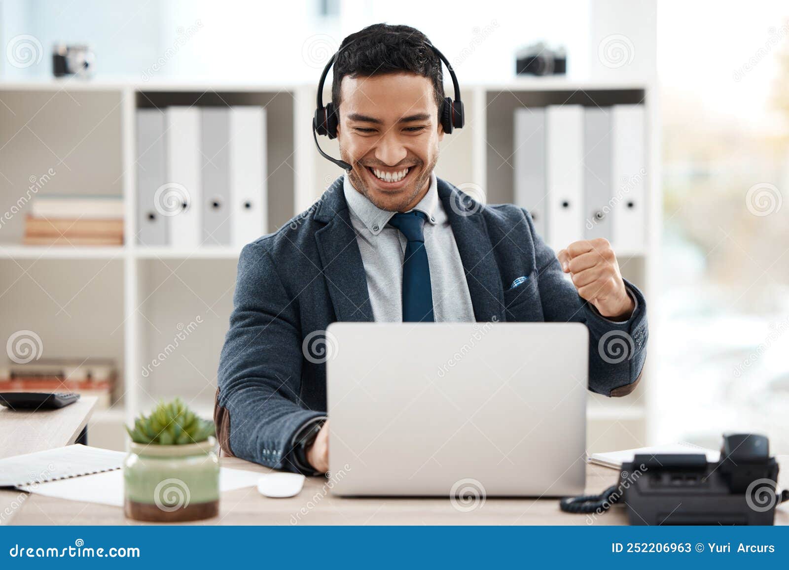 A Win for One is a Win for All. a Young Male Call Center Agent Cheering ...