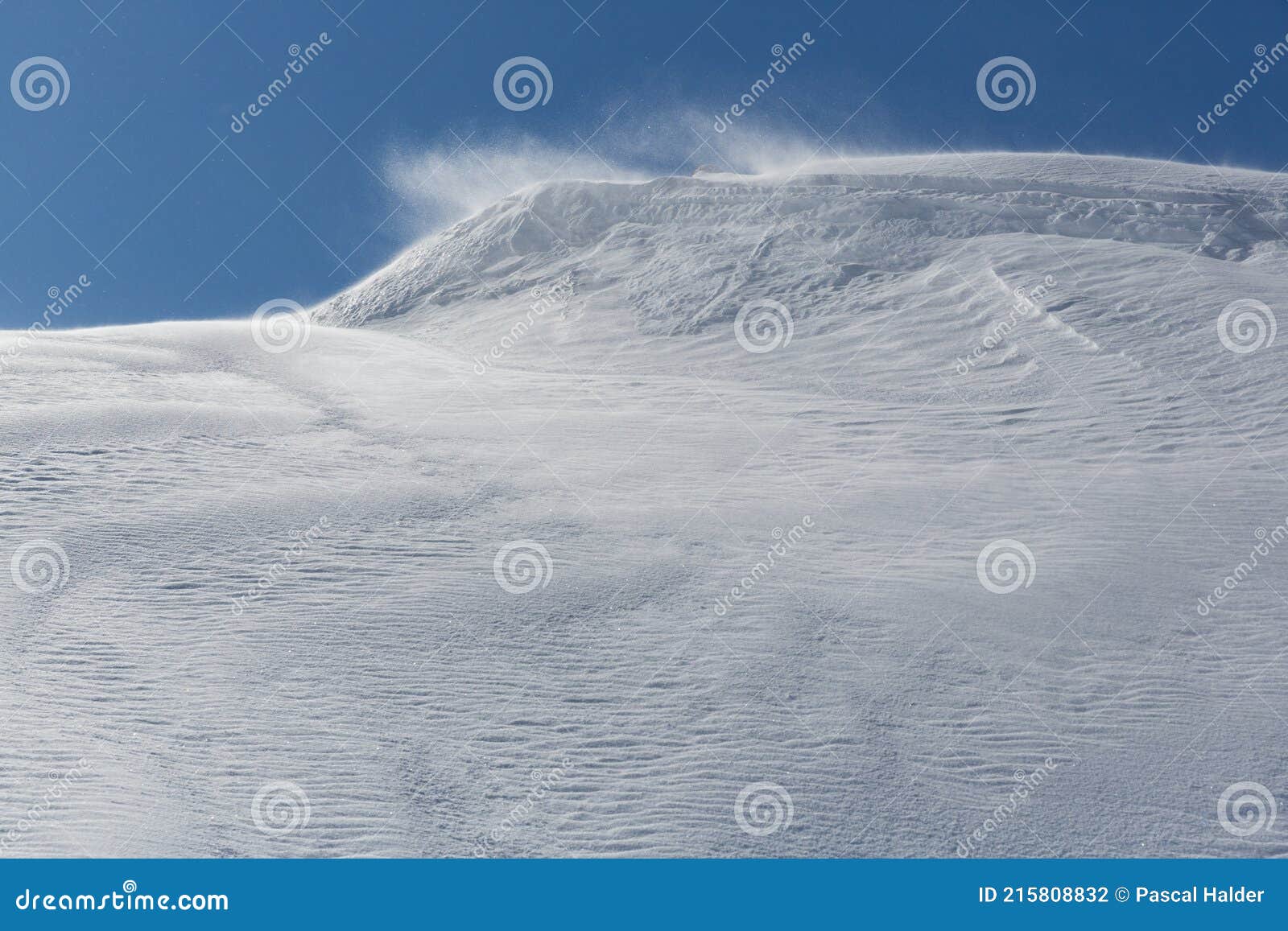 Wind Blowing Over Snow Cornice in Winter Landscape with Blue Sky Stock ...