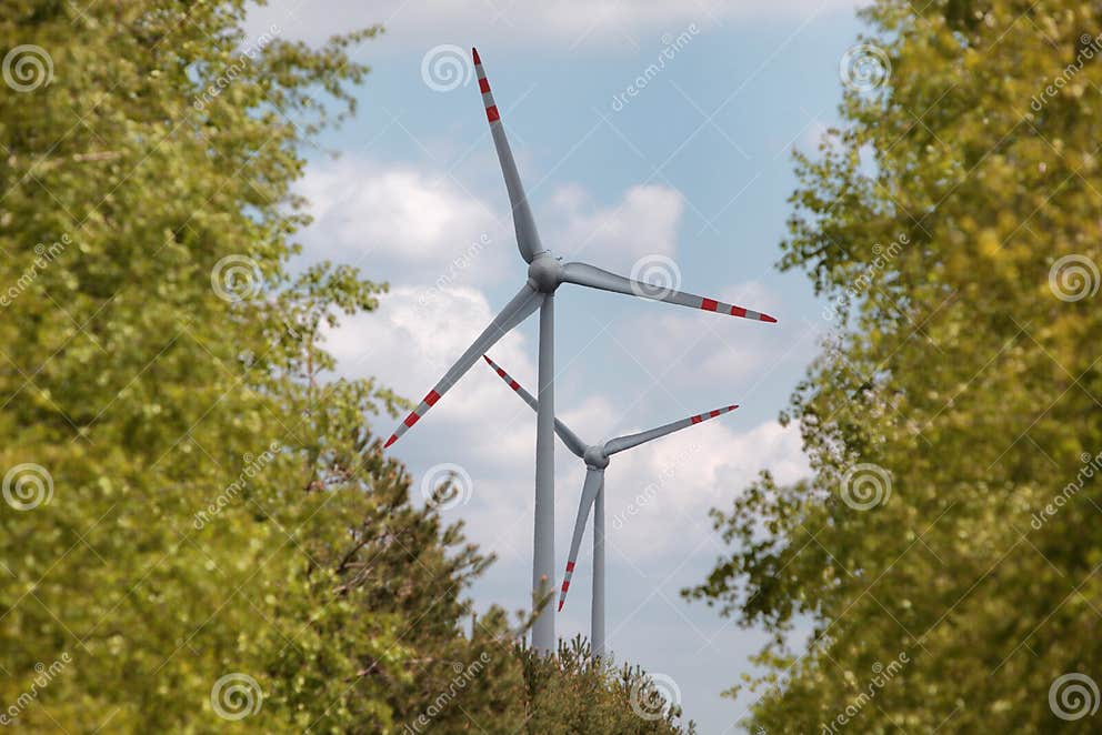 Wind Energy Turbines among Trees Stock Image - Image of electric, plant ...