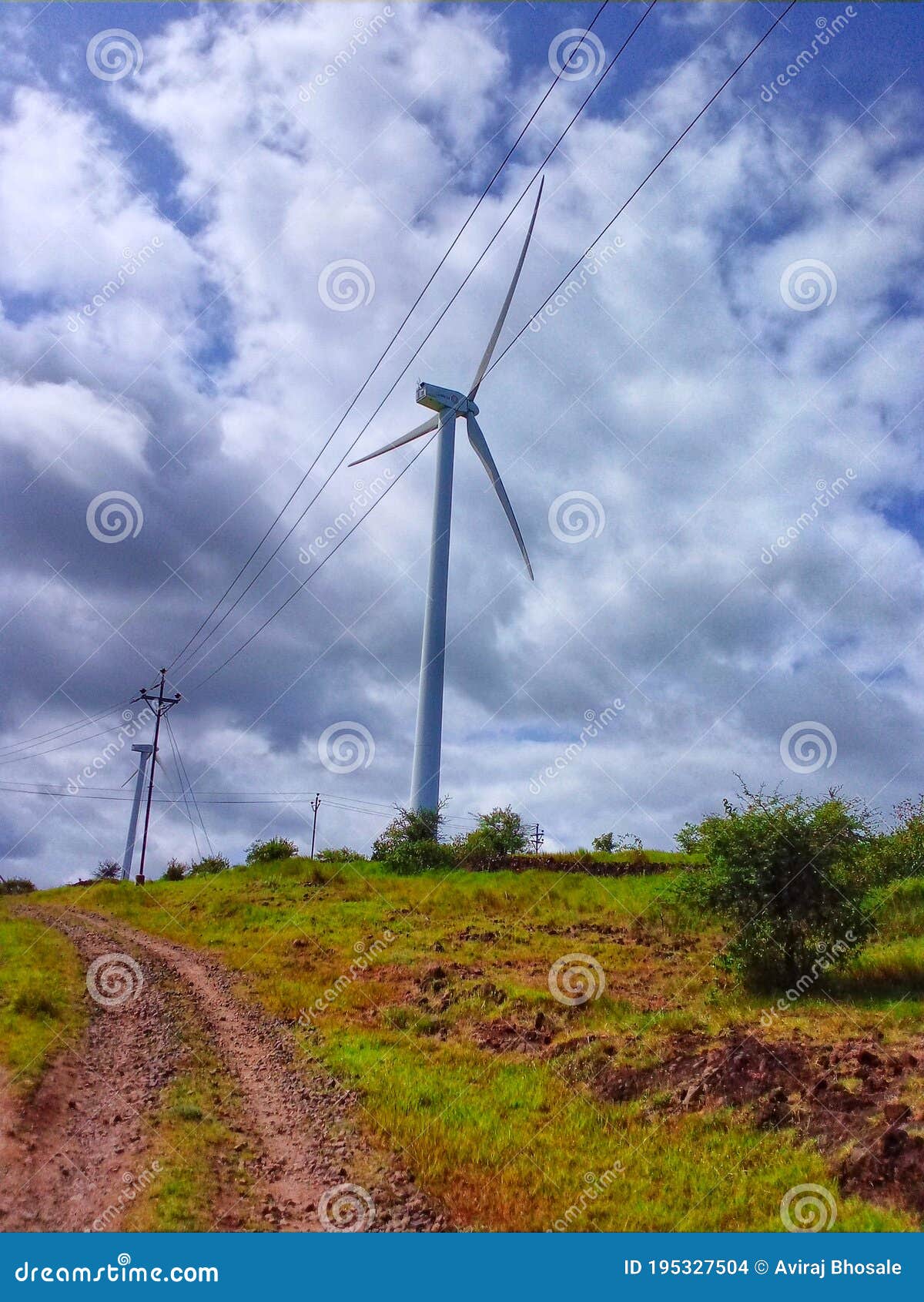 The wind mill on a road stock photo. Image of prairie - 195327504