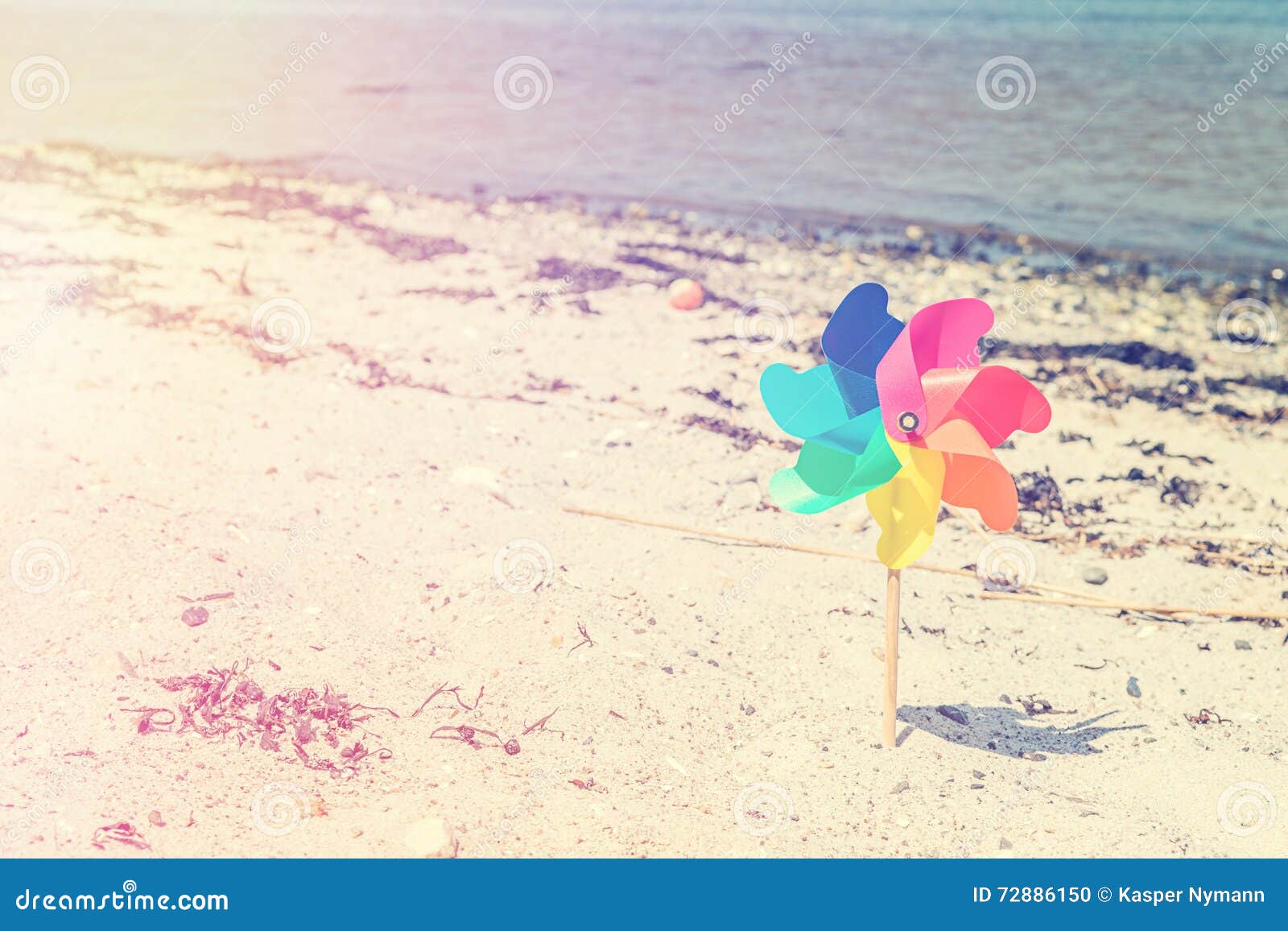 Wind mill toy on a beach stock photo. Image of nature - 72886150