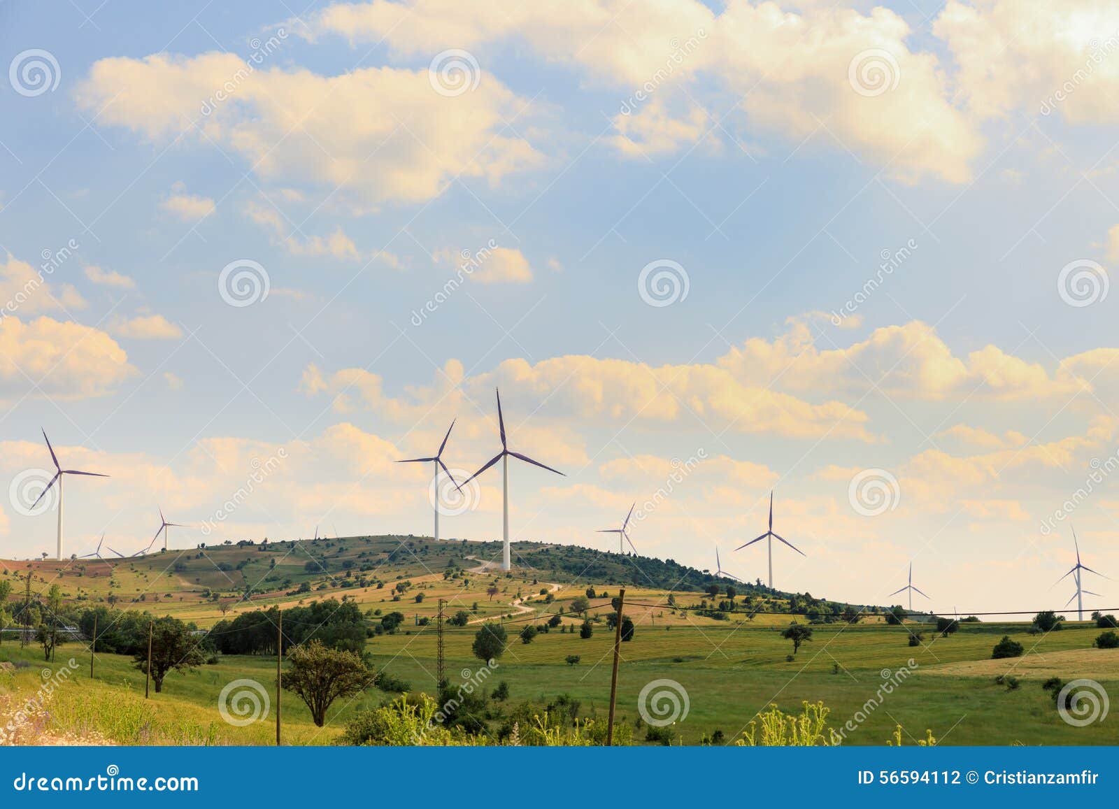 Wind power poles stock photo. Image of clouds, field - 56594112