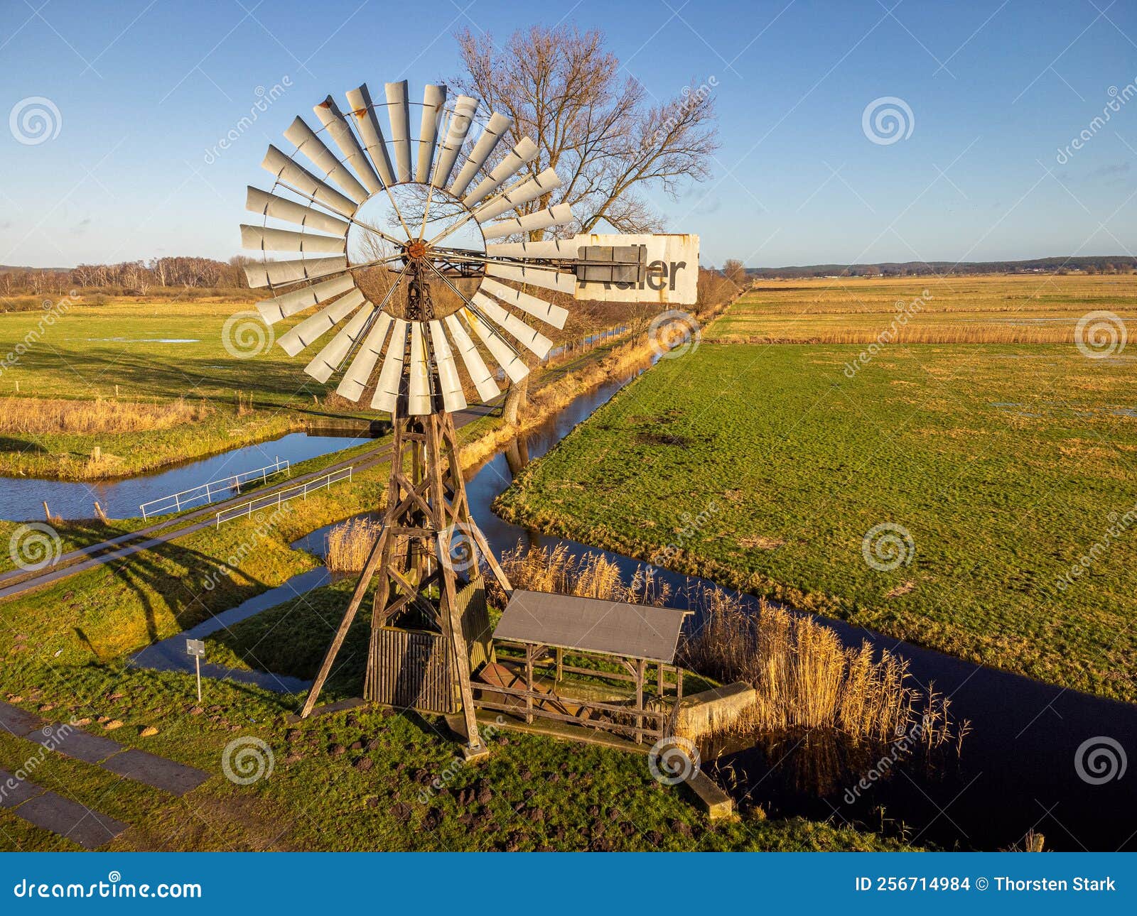 Wind Power Station Windmill on a River in the Middle of Fields and ...