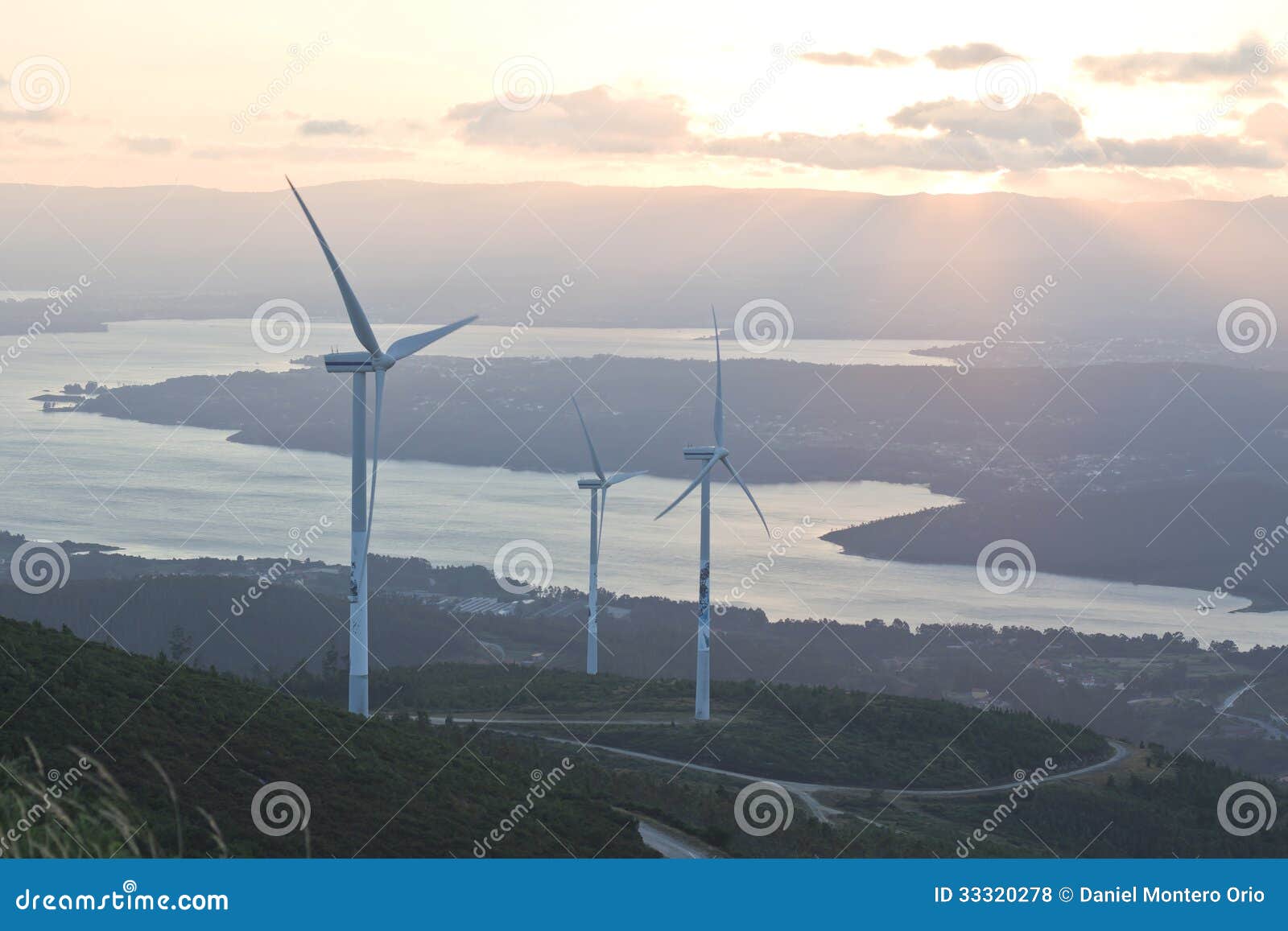 Wind Turbine Farm with Rays of Light at Sunset Stock Photo - Image of ...