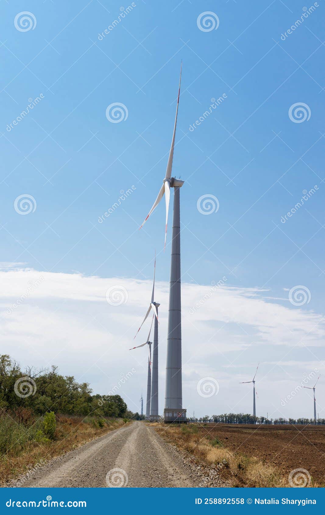Wind Turbine in a Large Field Above a Blue Overcast Sky Stock Photo ...