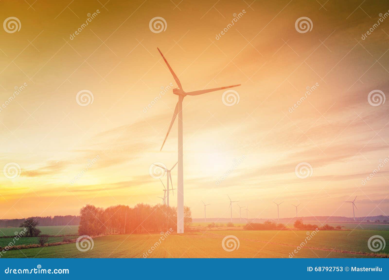 Wind turbine at sunset stock image. Image of development - 68792753