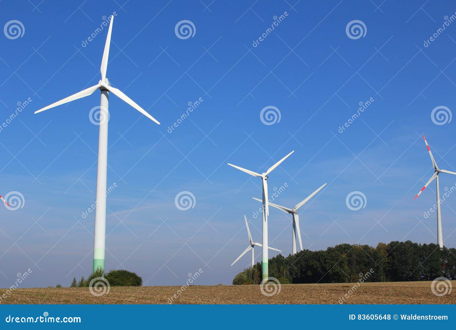 Wind turbines on a field stock photo. Image of generation - 83605648