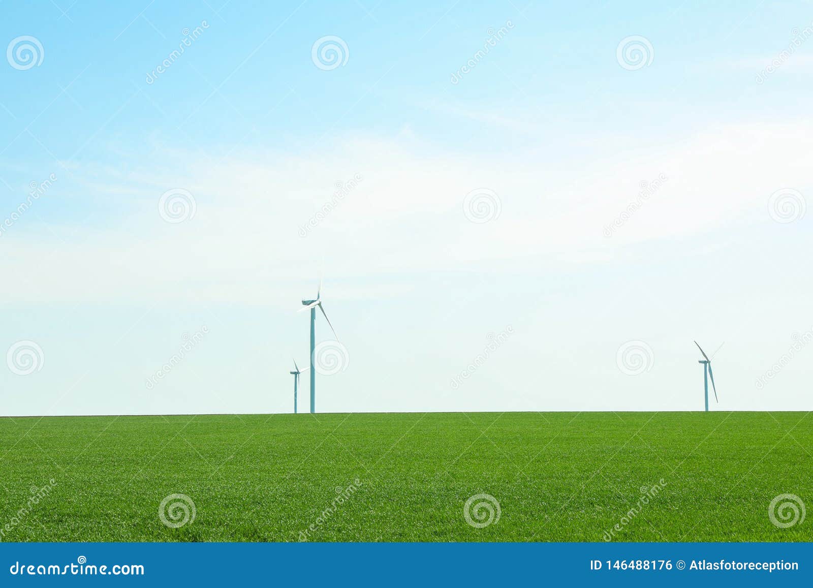 Wind Turbines in a Green Grass Field, Space for Text Stock Photo ...