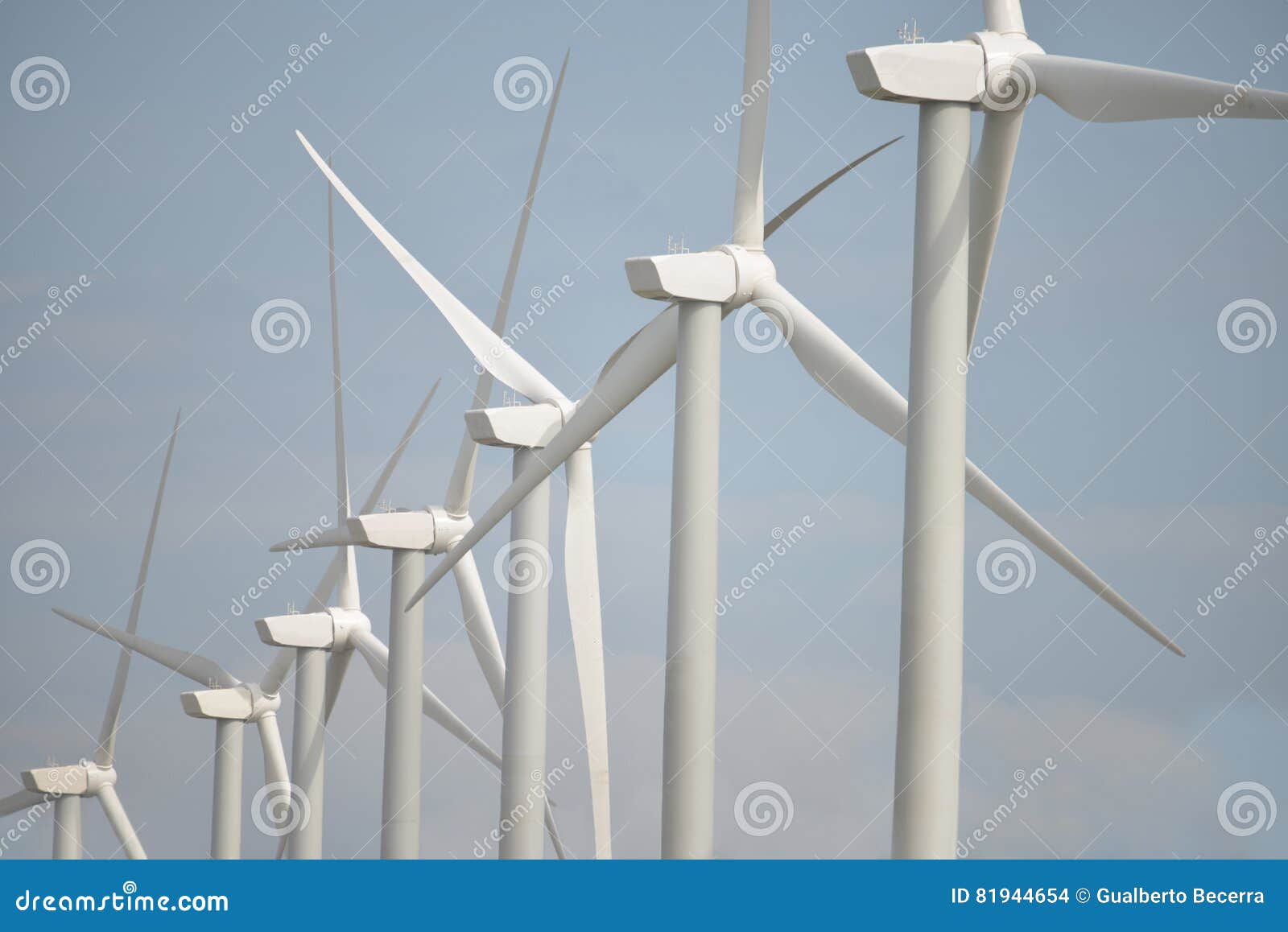 Wind turbines in a row stock photo. Image of close, conservation - 81944654