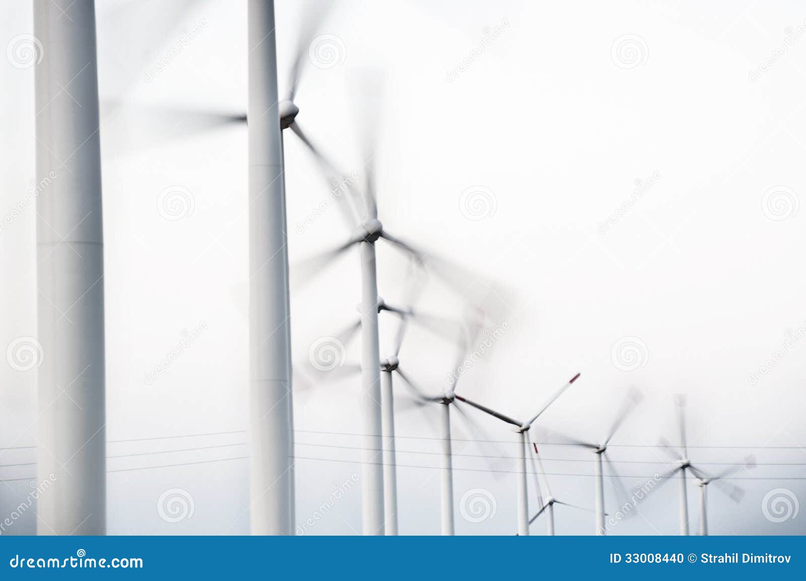 Wind turbines in a row stock photo. Image of regenerating - 33008440