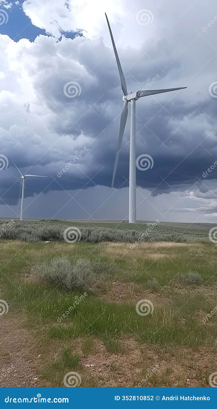 Wind Turbines Turning Steadily in a Remote Field with Storm Clouds ...