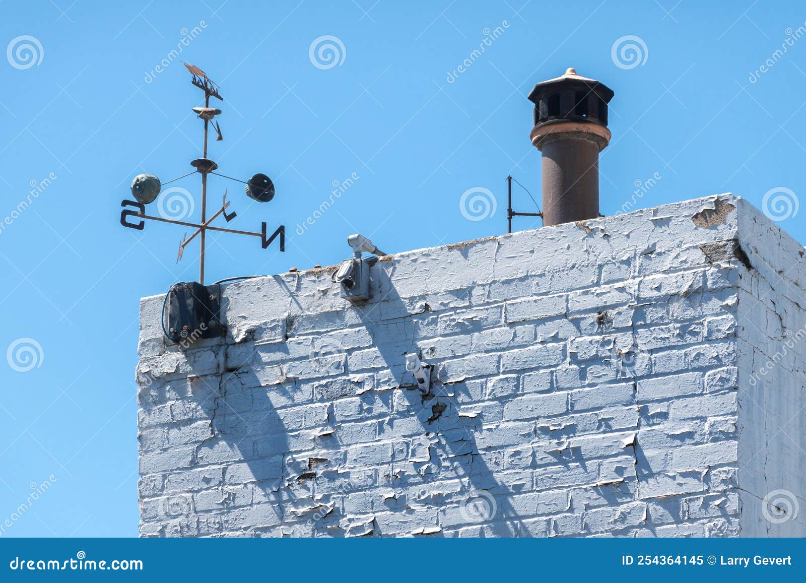 Wind vane on a chimney stock image. Image of direction - 254364145