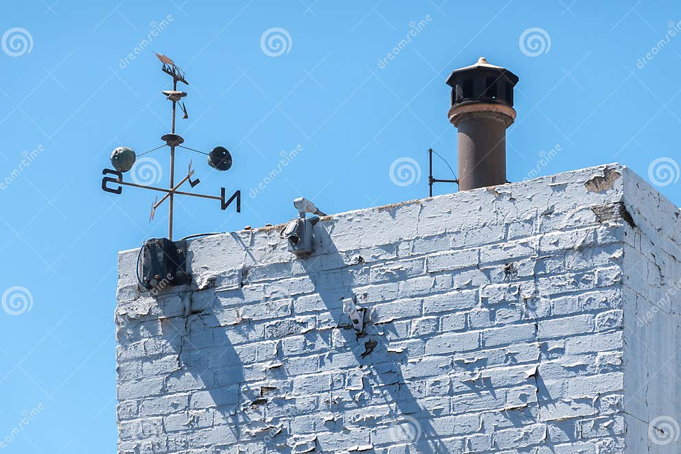 Wind vane on a chimney stock image. Image of direction - 254364145