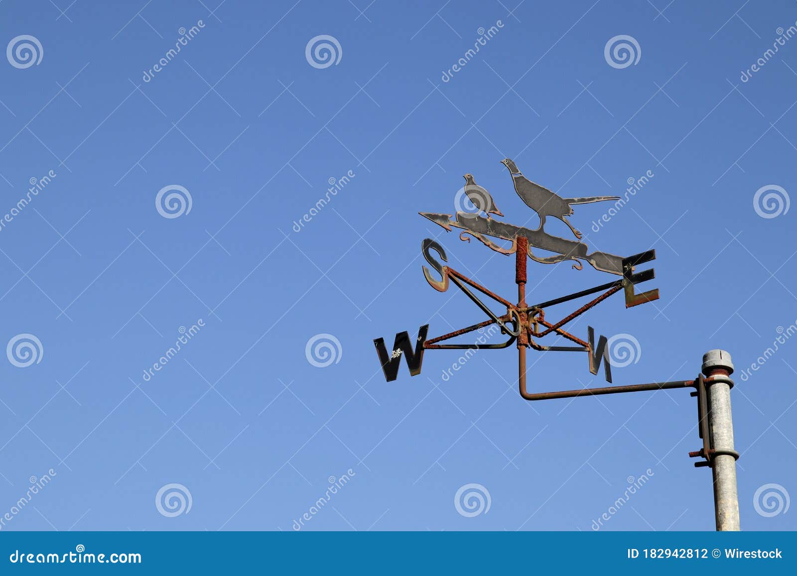 Wind Vane Isolated on a Blue Sky Background. Wind Direction and Weather ...
