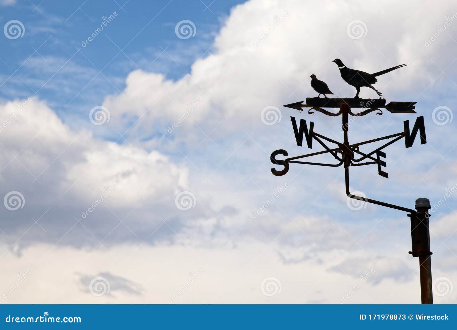 Wind Vane Isolated on a Cloudy Sky Background. Wind Direction Concept ...