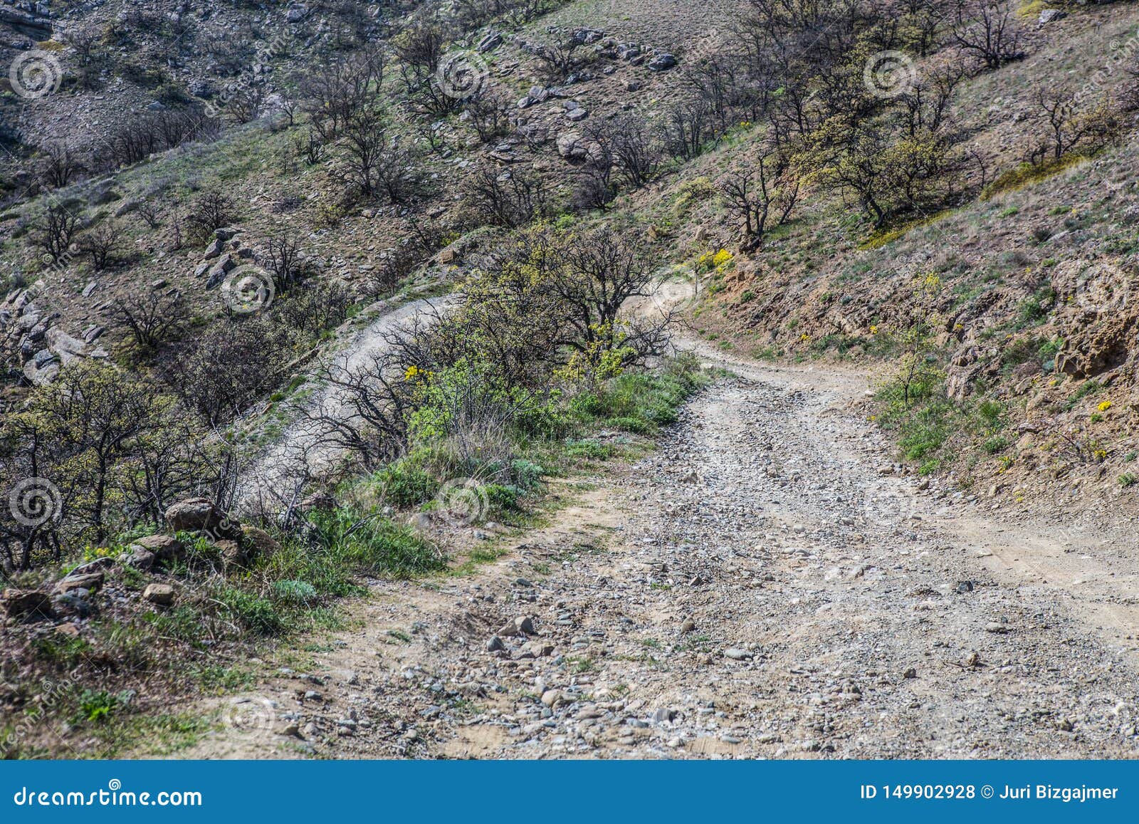 Winding dirt, rocky road stock photo. Image of mountains - 149902928
