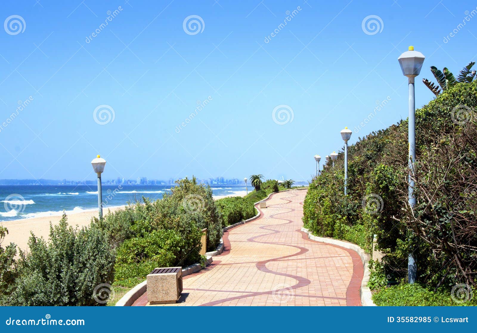 Winding Pedestrian Walkway with Beach and Ocean Backdrop Stock Image ...