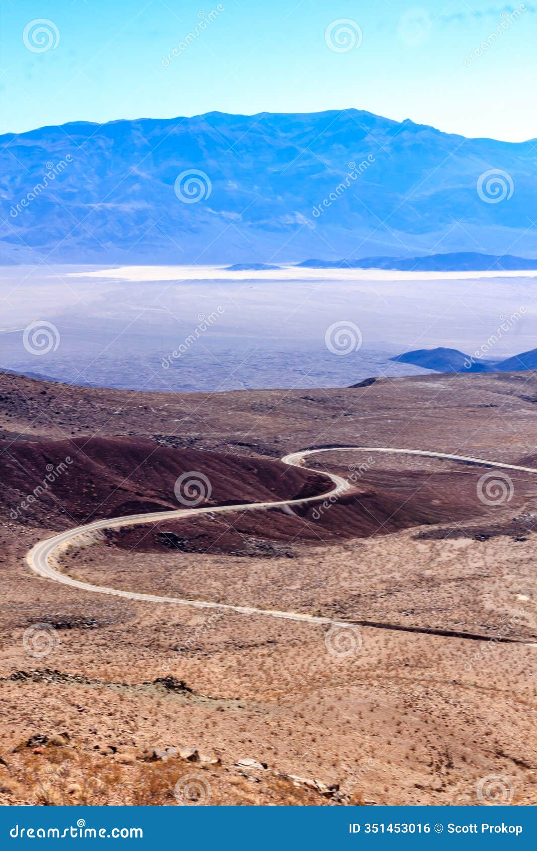 A Winding Road in the Desert with Mountains in the Background Stock ...
