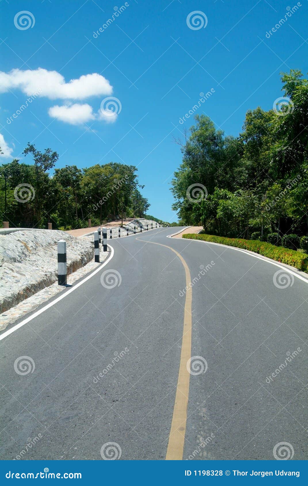 Winding road over a hill stock photo. Image of sidewalk - 1198328