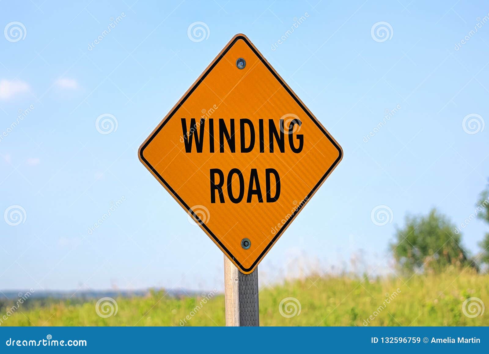 A Winding Road Sign Against a Blue Sky Stock Image - Image of curved ...