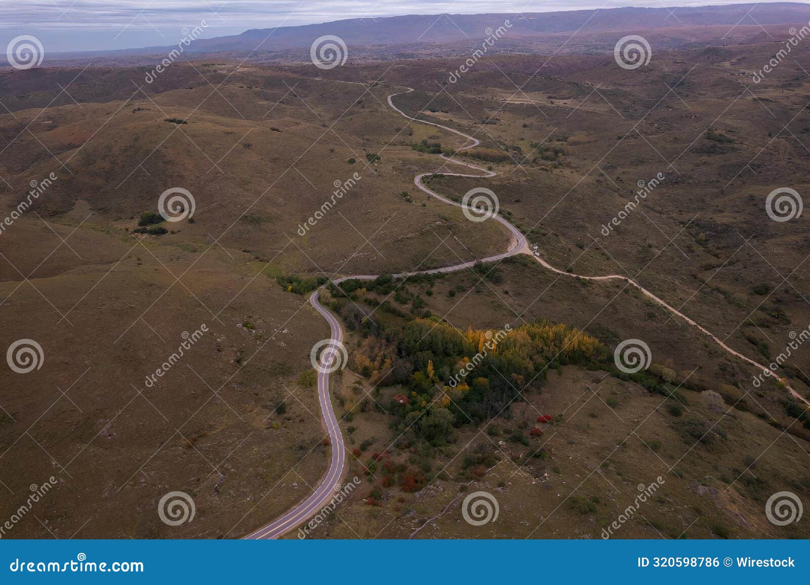 Winding Road Winding through a Landscape with Sparse Greenery Stock ...
