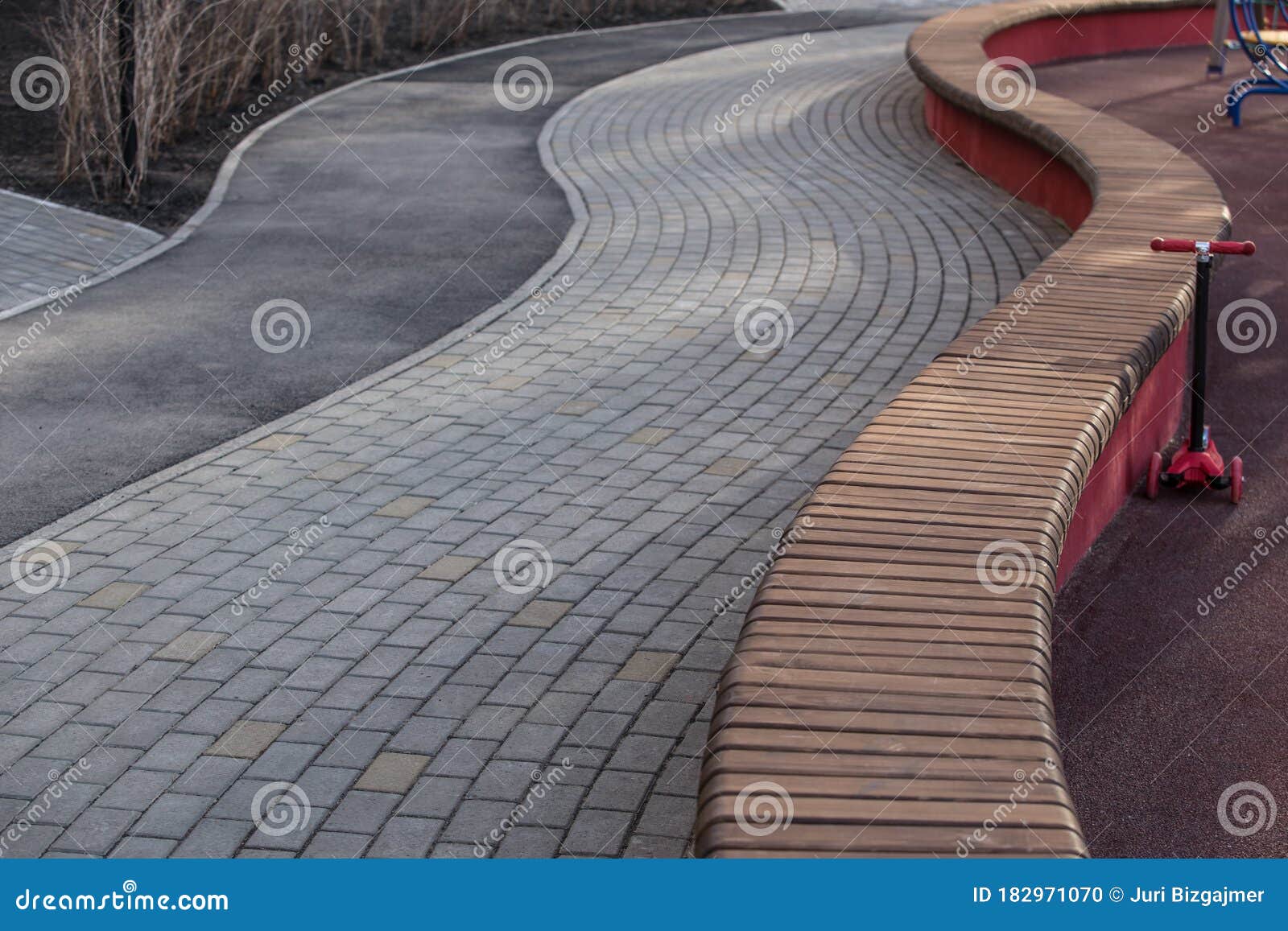 Winding Sidewalk with a Long Wooden Bench Stock Photo - Image of lawn ...