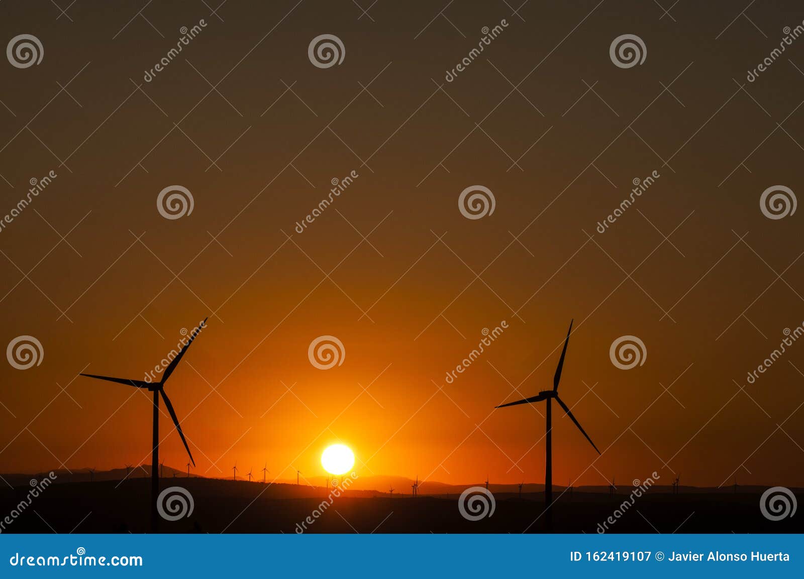 Windmill field at sunset stock image. Image of field - 162419107