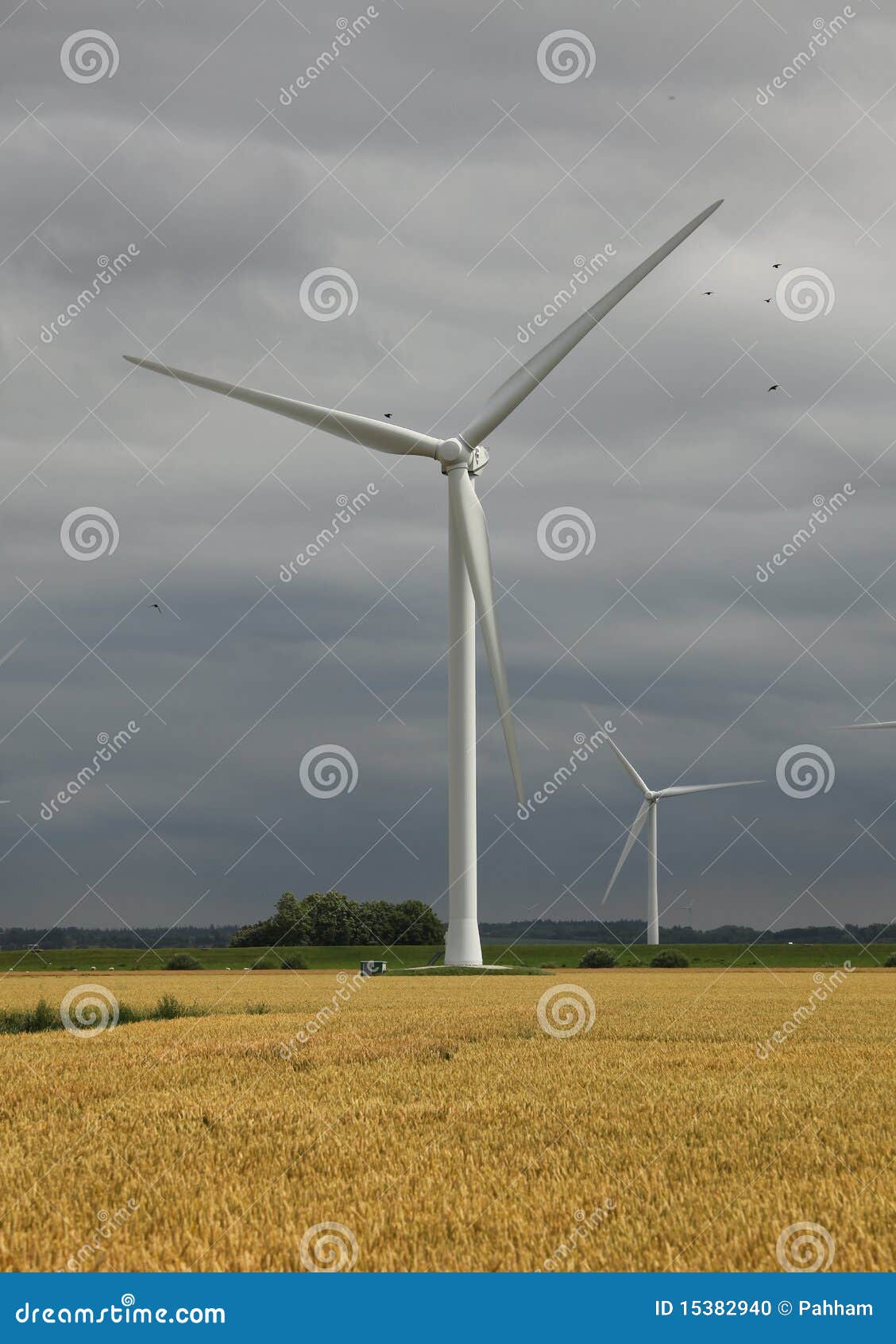 A Windmill in Front of a Cloudy Sky Stock Photo - Image of ...