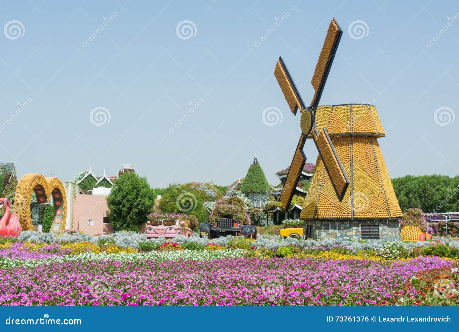 Windmill in the Garden Near Flower Field Editorial Photo - Image of ...
