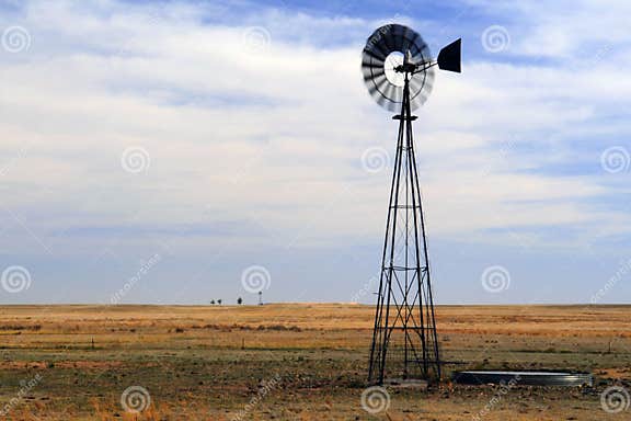 Windmill on Great Plains stock photo. Image of clouds - 5291668