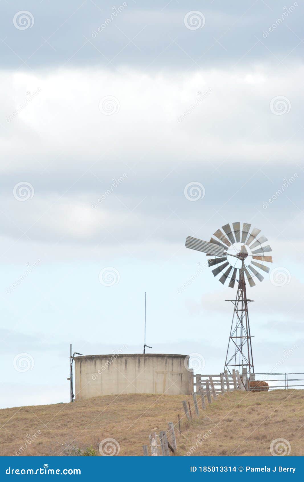 A Windmill on a hill stock photo. Image of water, fence - 185013314