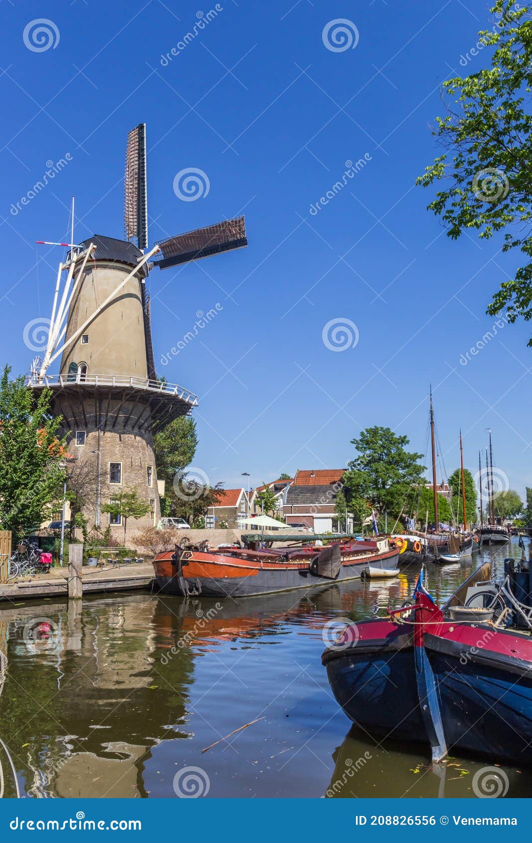 Windmill and Historic Ships at the Canal in Gouda Stock Photo - Image ...