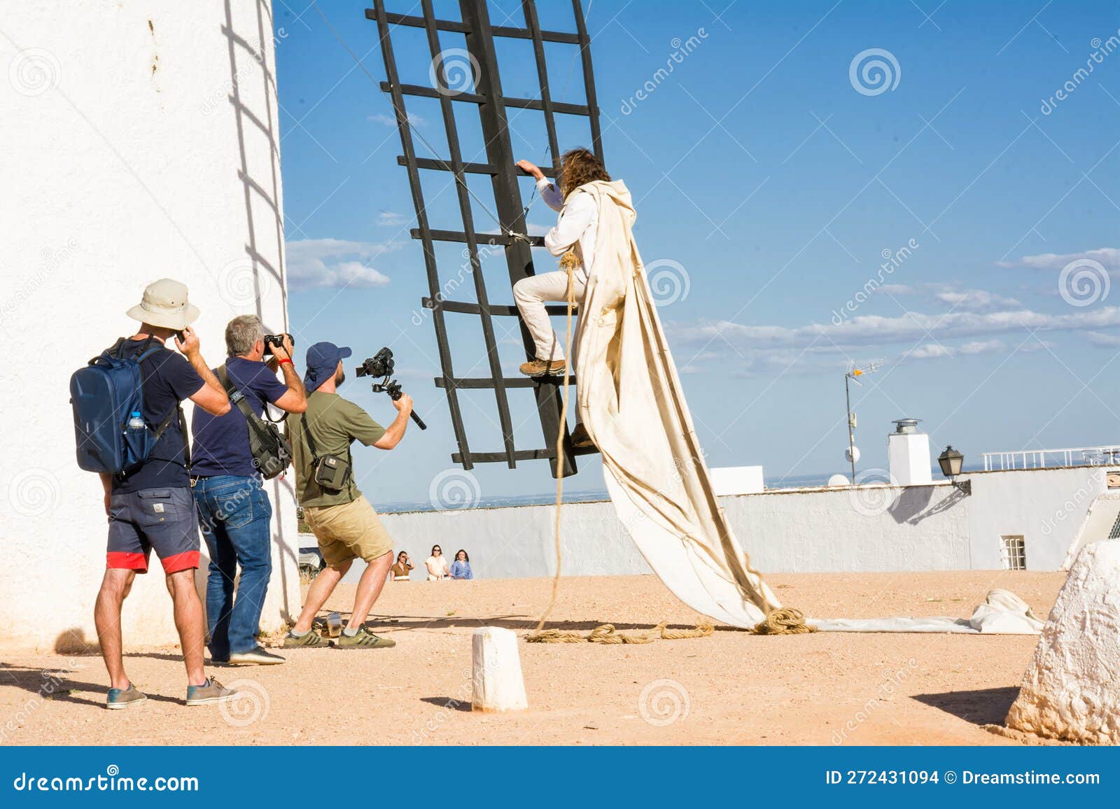 Windmill with Man Climbing on the Blades To Install the Cloth To Make ...