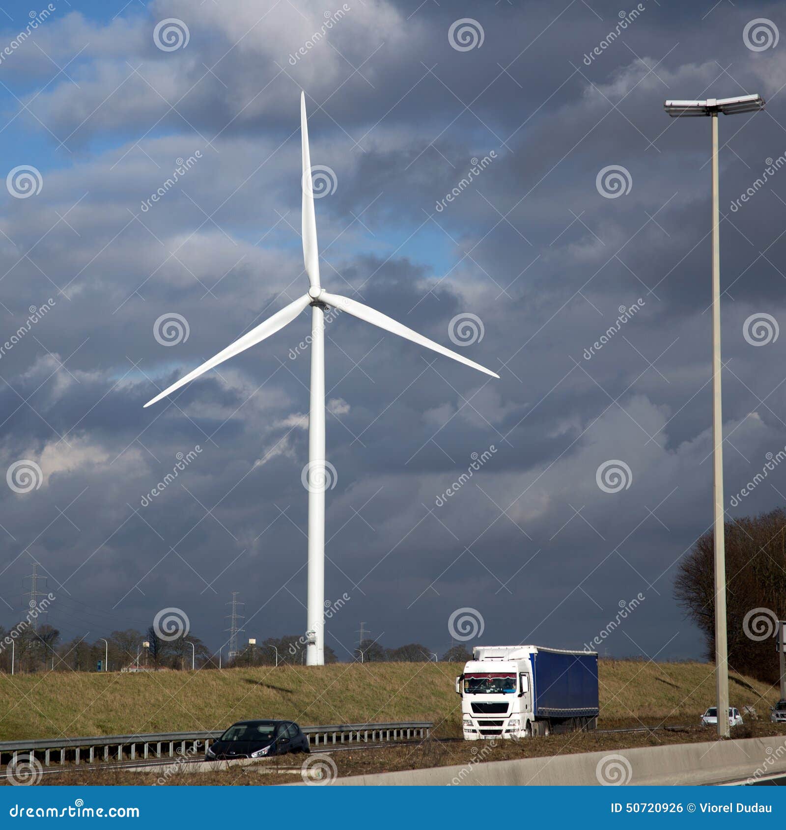 Windmill next to highway stock photo. Image of driving - 50720926