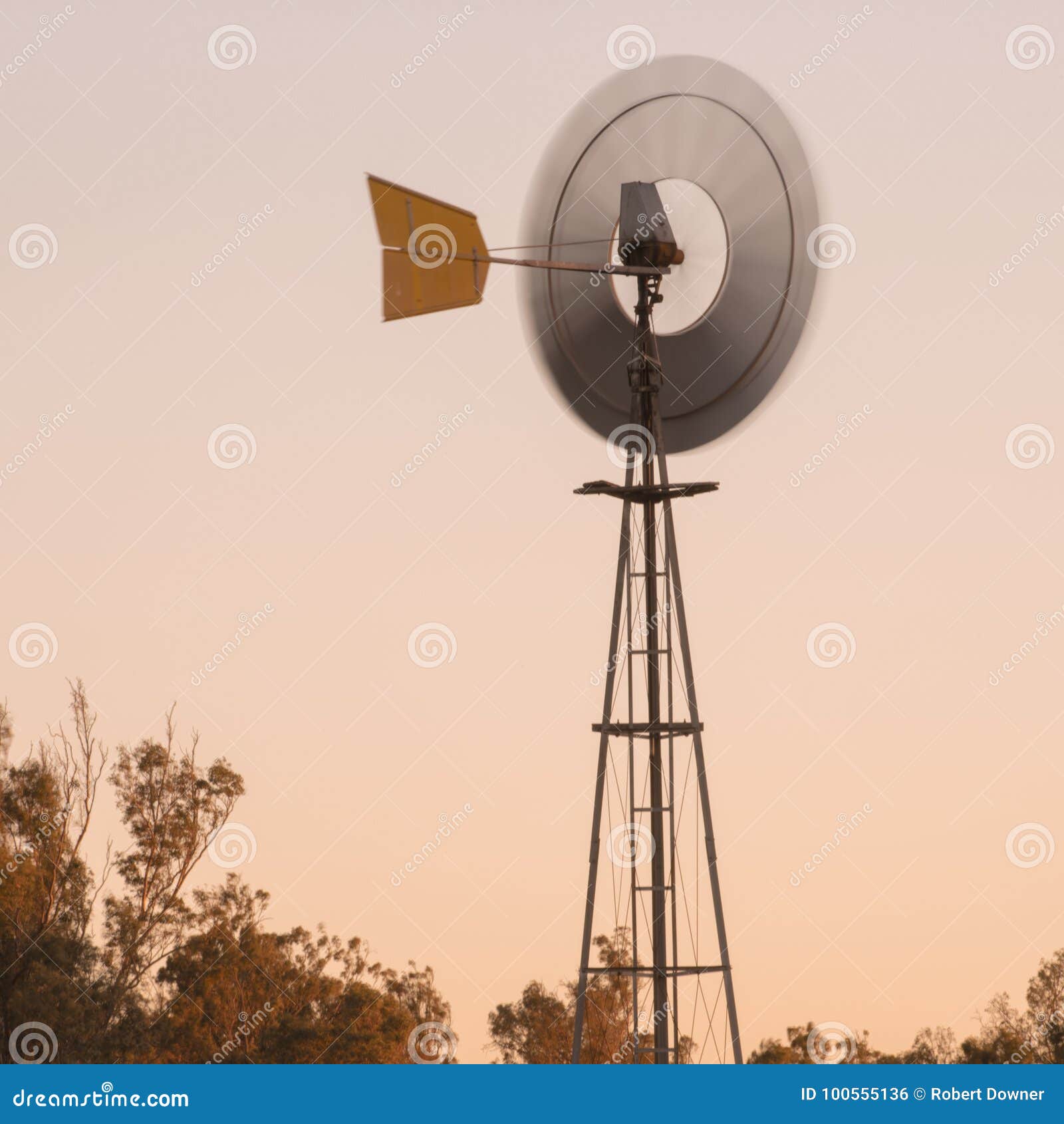 Windmill in a paddock stock photo. Image of pasture - 100555136