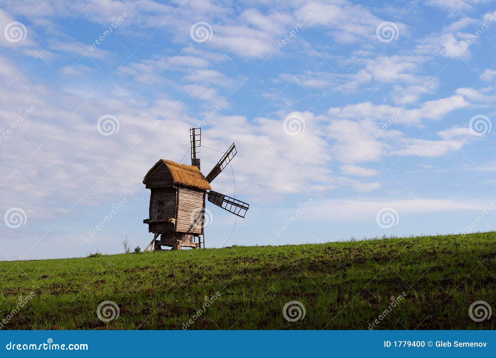 Windmill with a straw roof stock photo. Image of field - 1779400