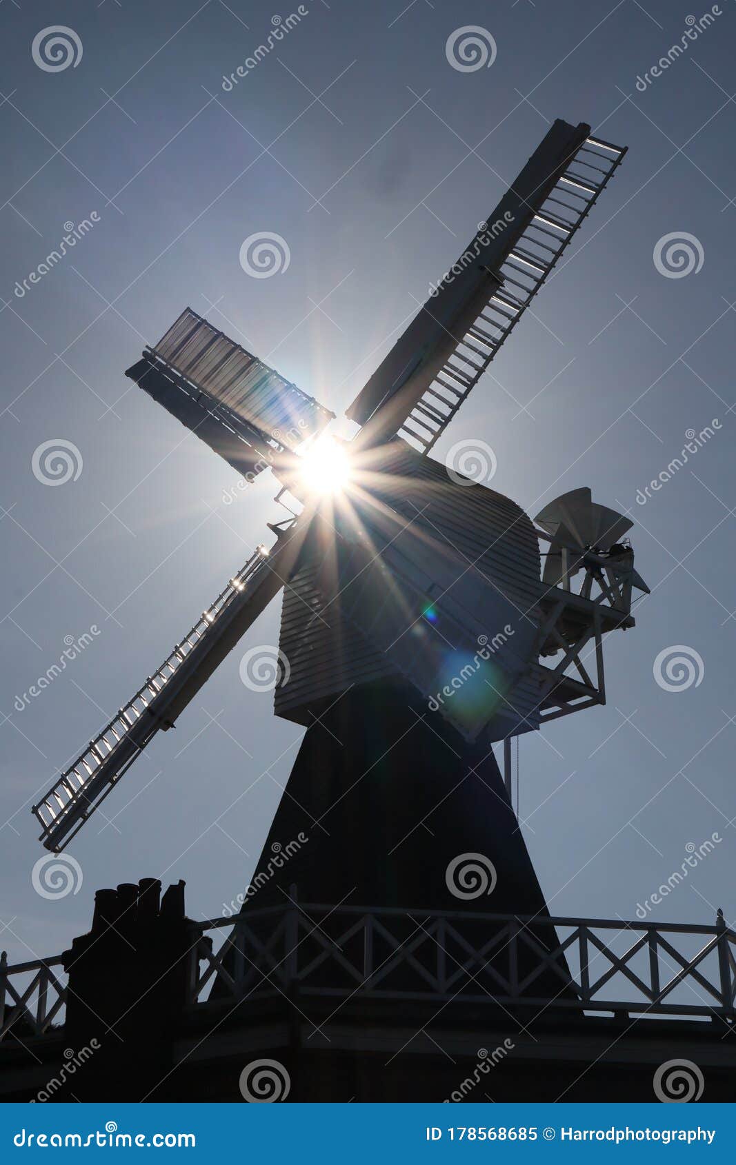 A Windmill with the Sun Shining through the Middle Stock Image - Image ...